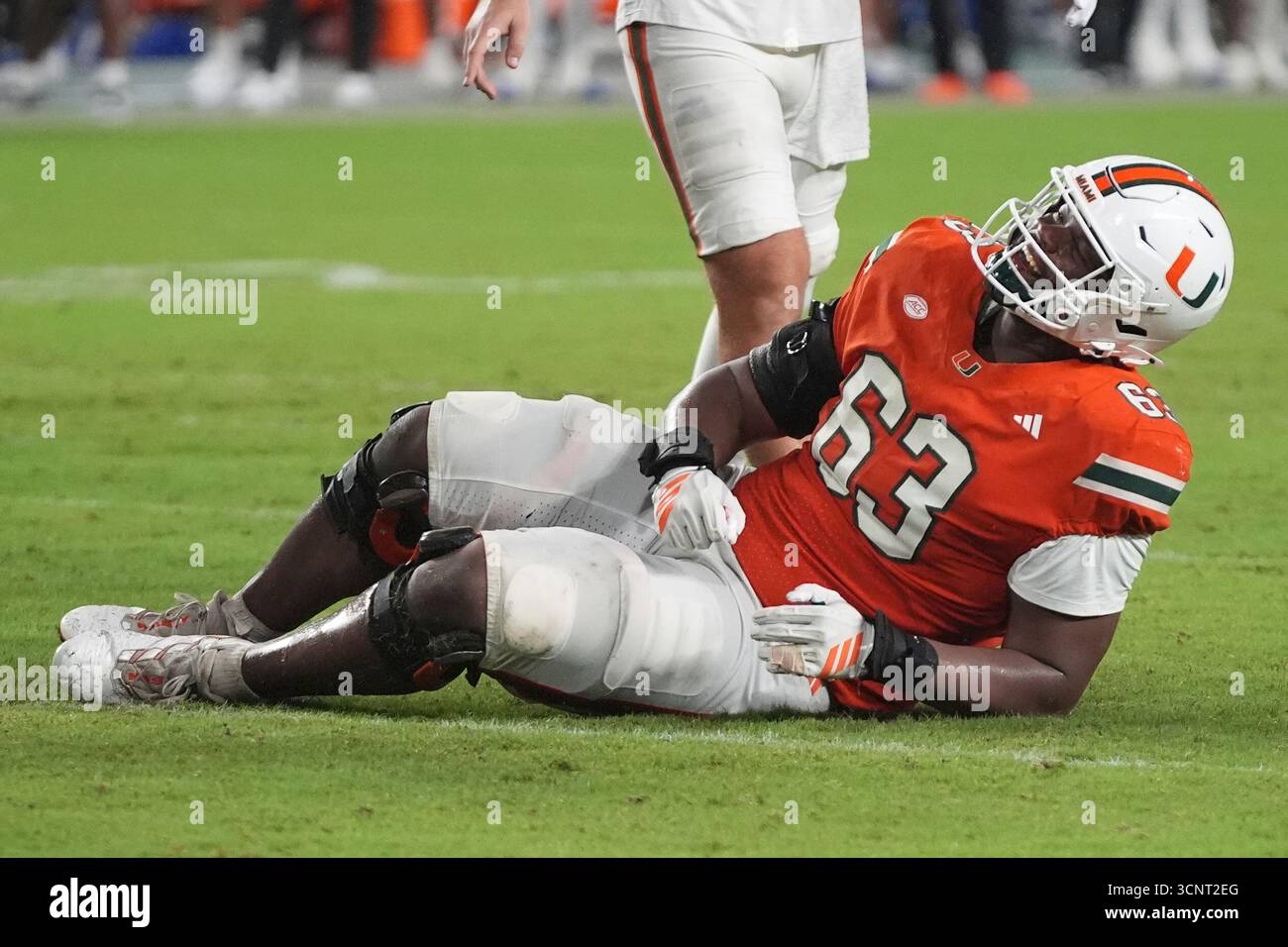 Miami offensive lineman Samson Okunlola (63) lies on a field after ...