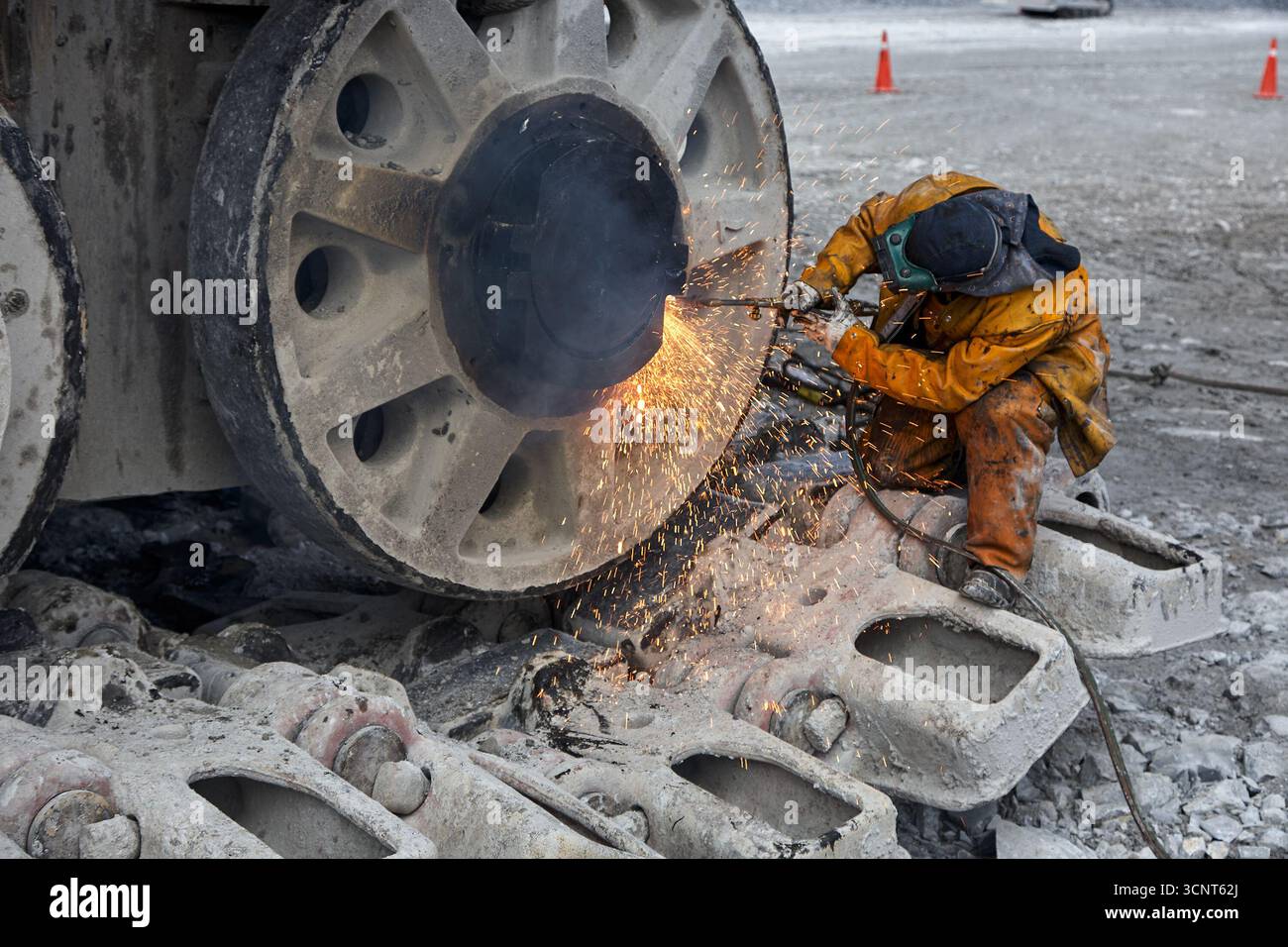 Skilled mechanics hard at work on the massive crawlers of this electric ...