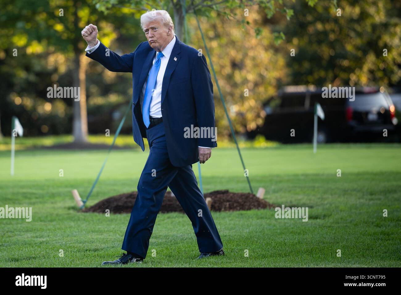 President Donald Trump walks on the South Lawn of the White House to ...