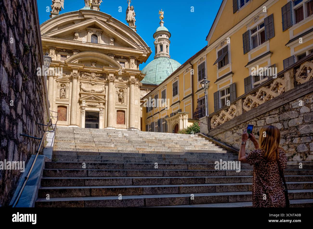 A woman taking photos of the Church of the Holy Trinity ...