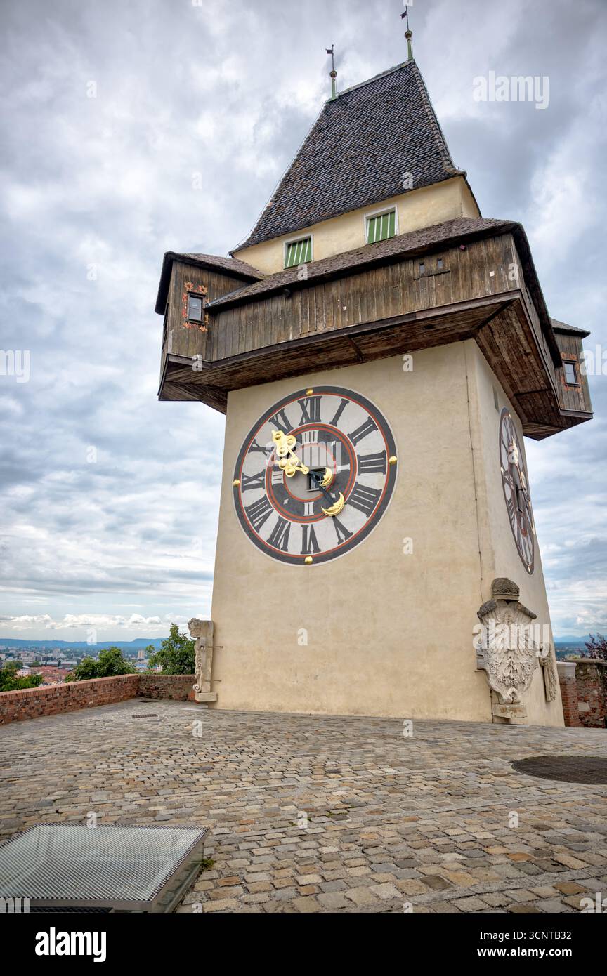 The iconic Uhrturm (Clock Tower) on Schlossberg Hill stands tall above ...