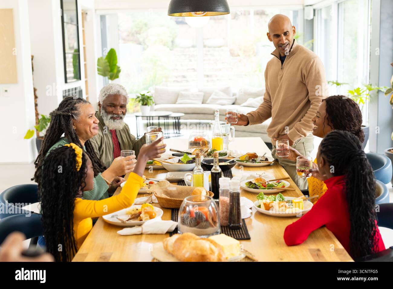 Diverse family gathering around wooden hi-res stock photography and ...
