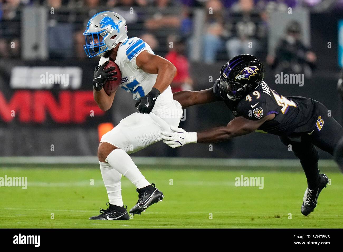 Detroit Lions' Jacob Saylors,, left, returns the opening kickoff as ...