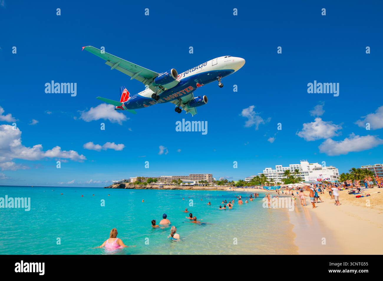 JetBlue Airways Airbus 320 flying over Maho Beach before landing on ...