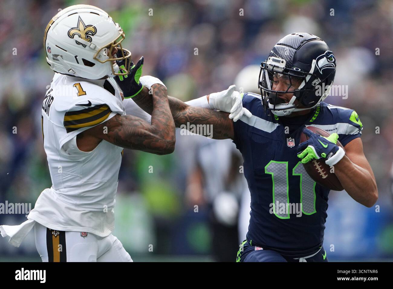 Seattle Seahawks wide receiver Jaxon Smith-Njigba (11) stiff-arms ...