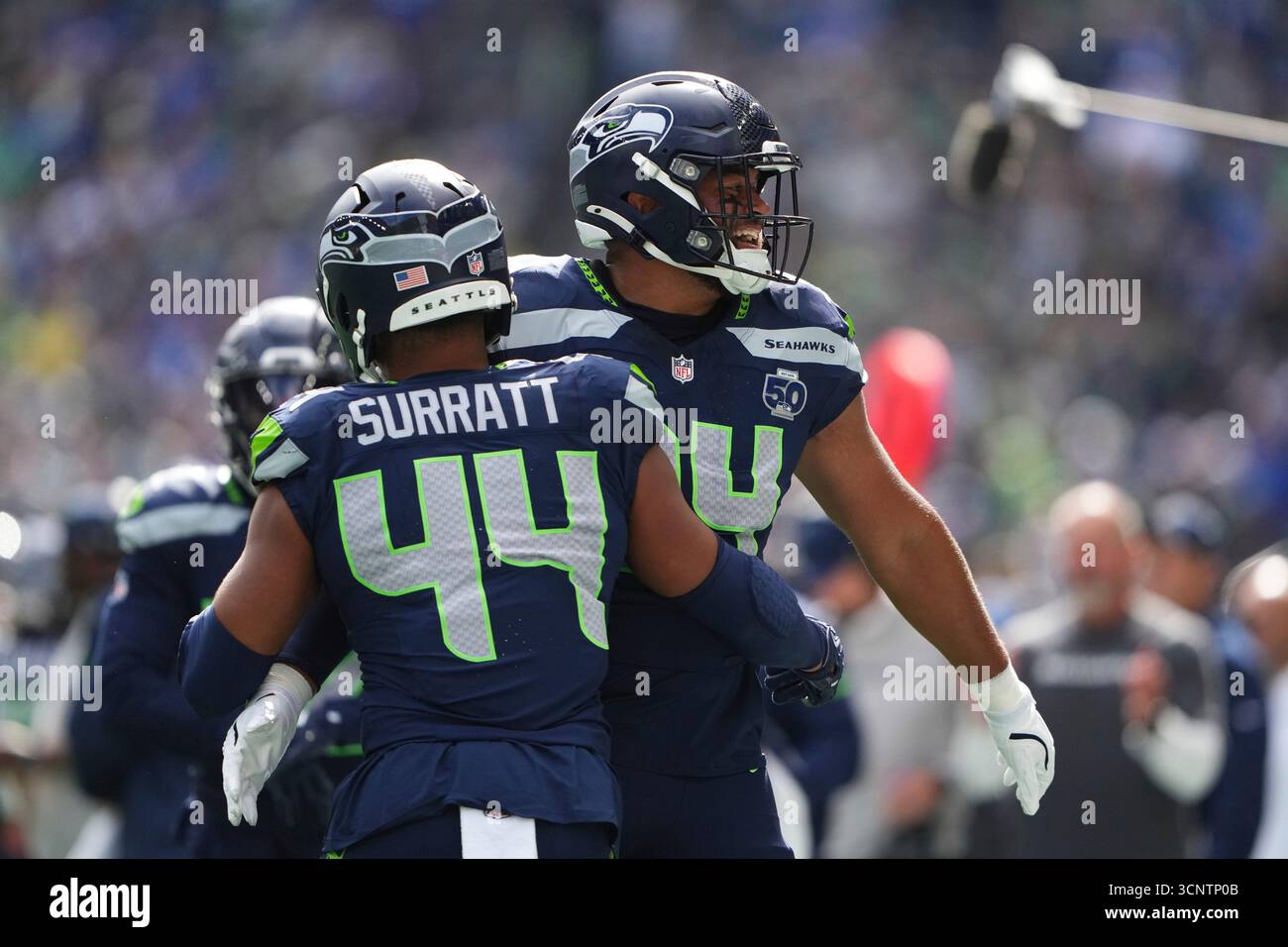 Seattle Seahawks defensive end Mike Morris, facing, celebrates with ...