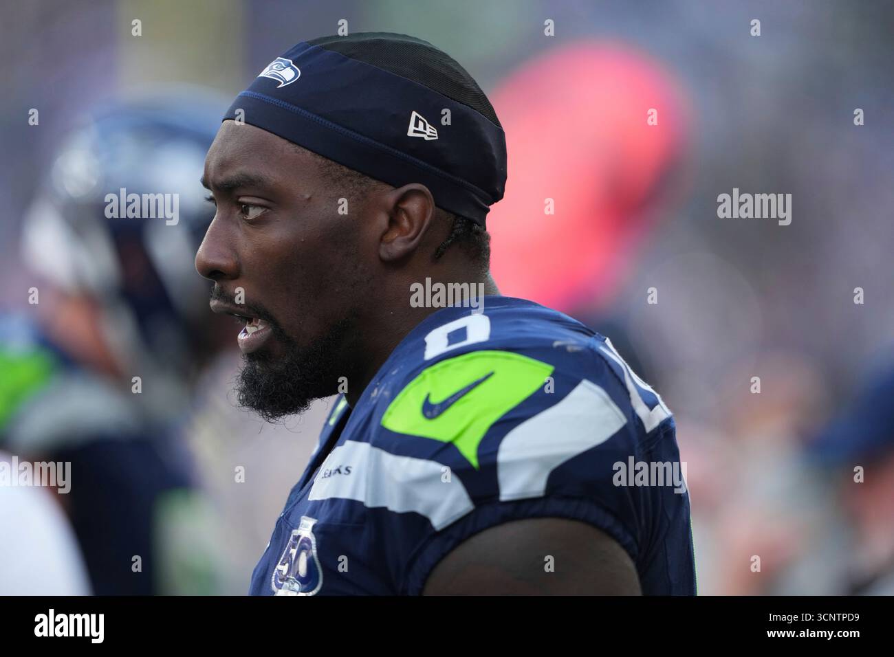 Seattle Seahawks linebacker DeMarcus Lawrence watches from the sideline ...