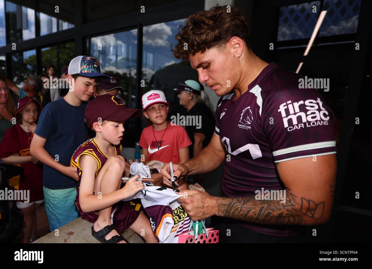 Reece Walsh of the Broncos interacts with fans after training in ...