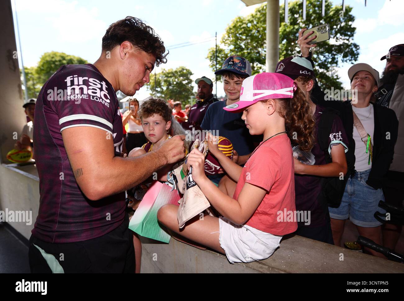 Reece Walsh of the Broncos interacts with fans after training in ...