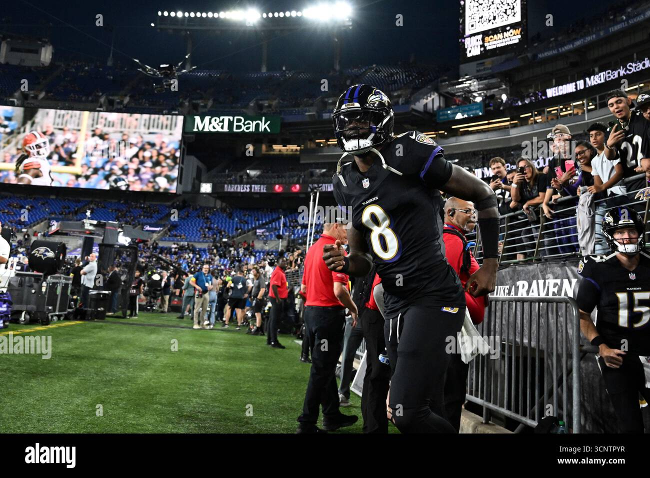 Baltimore Ravens quarterback Lamar Jackson (8) runs onto the field ...