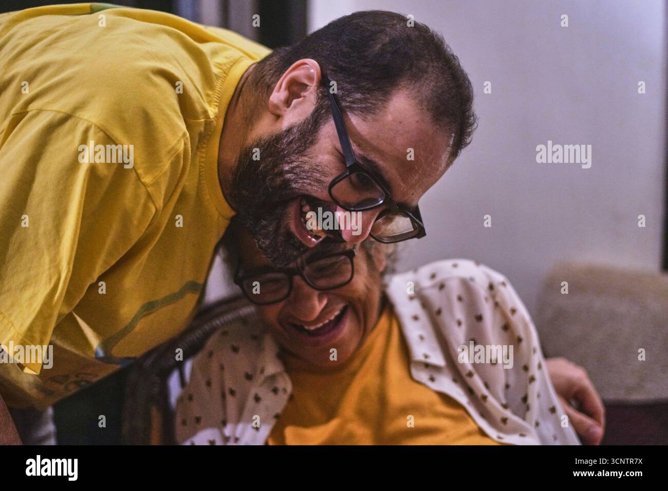 Activist Alaa Abd el-Fattah hugs his mother Laila Soueif, as he arrives ...