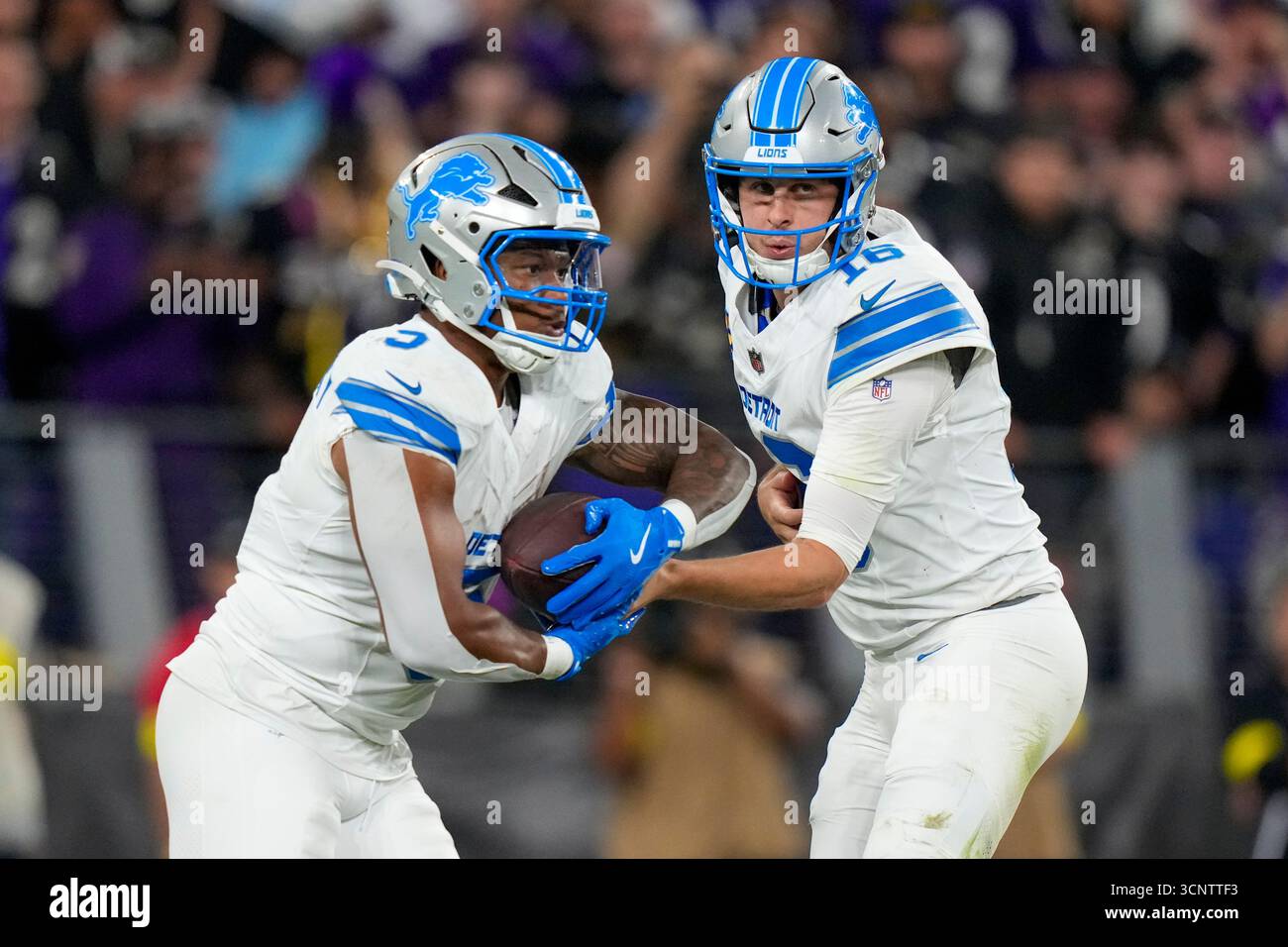 Detroit Lions quarterback Jared Goff, right, hands the ball off to ...