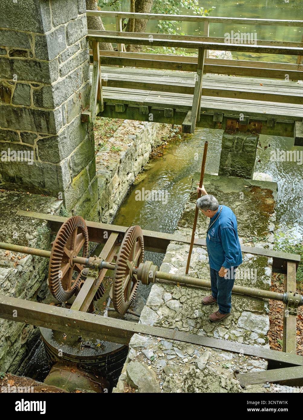 A docent inspects power transmission gears at Hagley Museum in ...