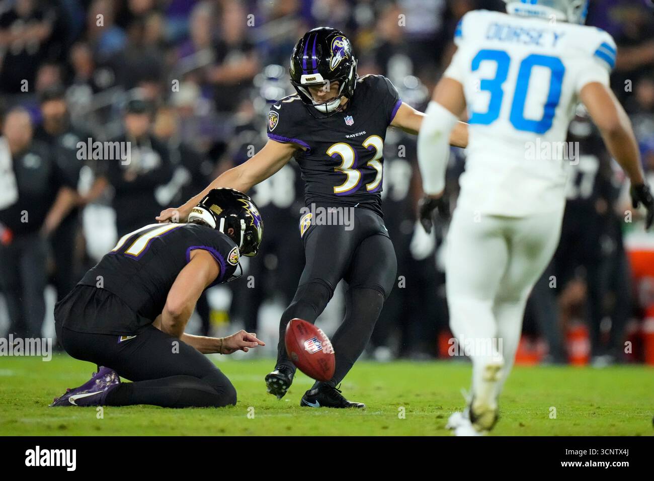 Baltimore Ravens kicker Tyler Loop (33), with Jordan Stout (11) holding ...