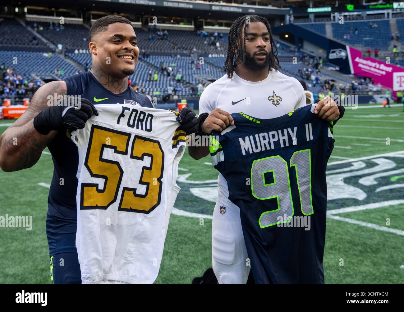 defensive lineman Byron Murphy II, left, and New Orleans Saints ...