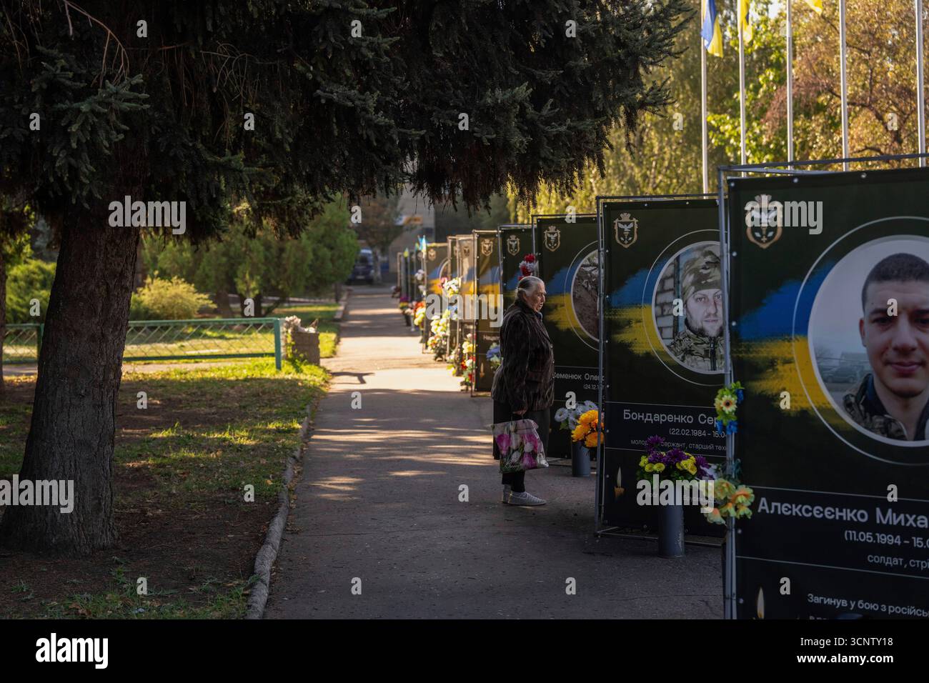 A woman cries while she looks at portraits of fallen servicemen in ...