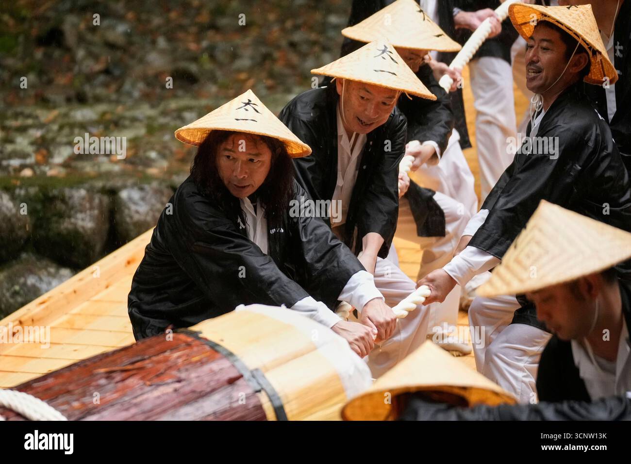 People carry a hinoki timber, Japanese cypress, into the Ise Jingu ...