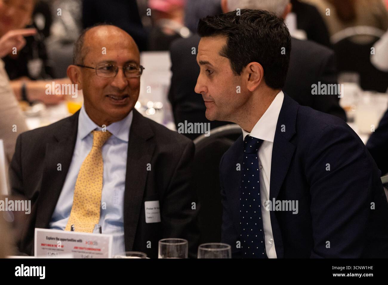 Queensland Premier David Crisafulli (right) and Peter Varghese ...