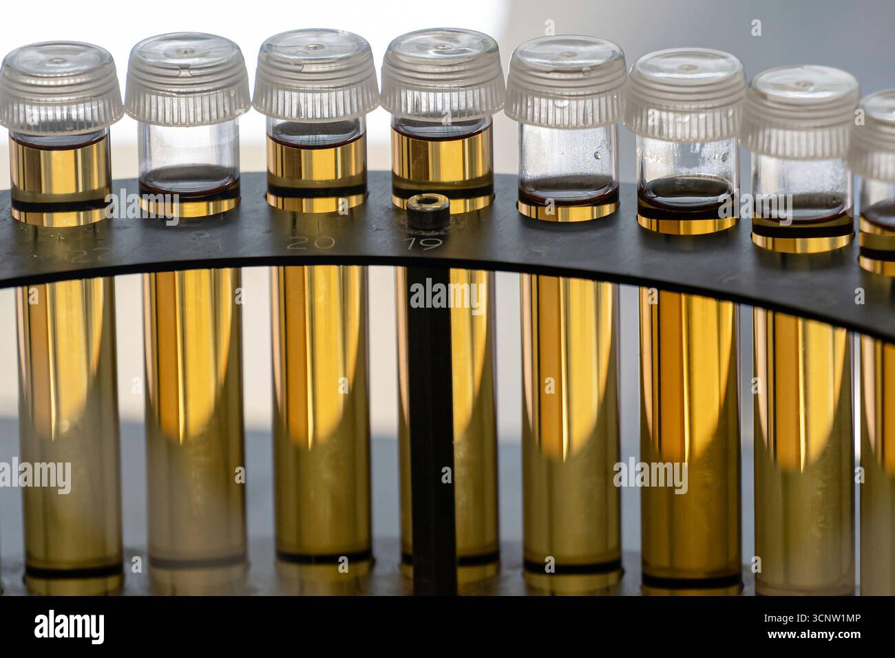 Containers of bourbon being tested in a machine are seen in the lab at ...