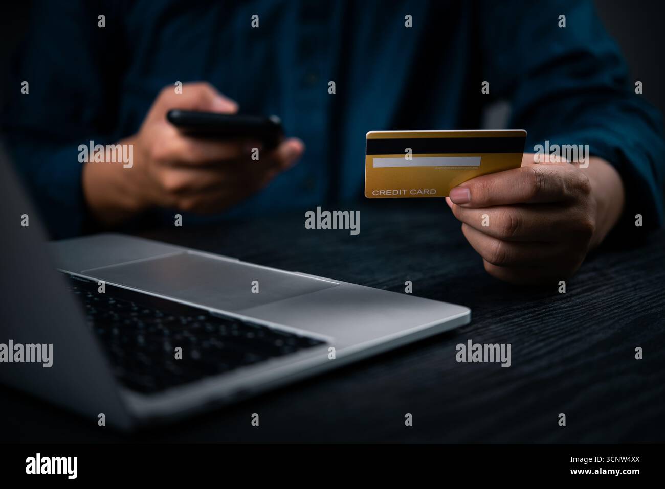 Hand holding credit card and mobile phone for online payment. Digital ...