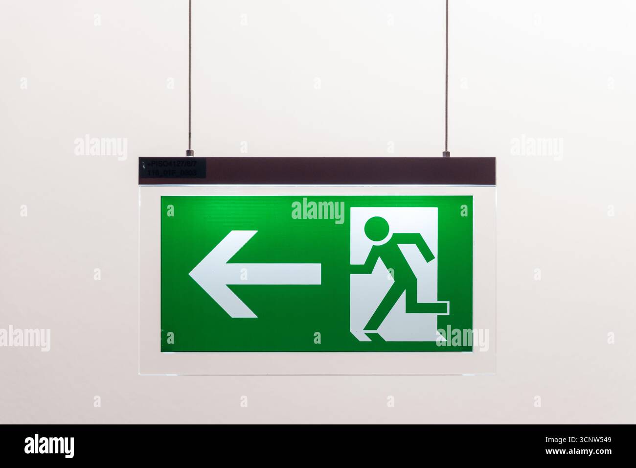 Illuminated emergency exit sign with a person icon and an arrow ...