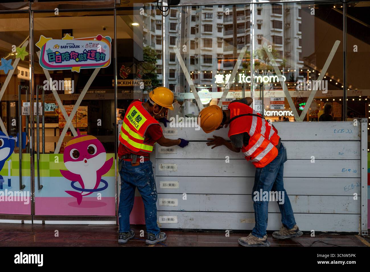 Hong Kong Prepares for Typhoon Ragasa Workers installing water ...
