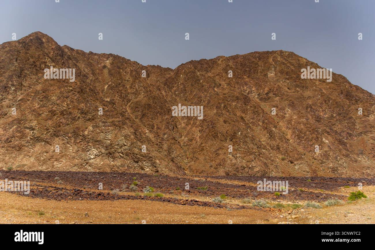 Arid Mountains Rise Under Pale UAE Sky Stock Photo - Alamy