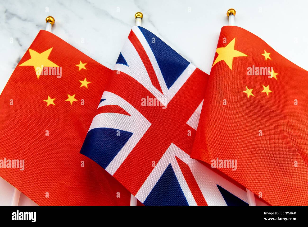 The United Kingdom Union Jack on flag pole in between the Chinese ...