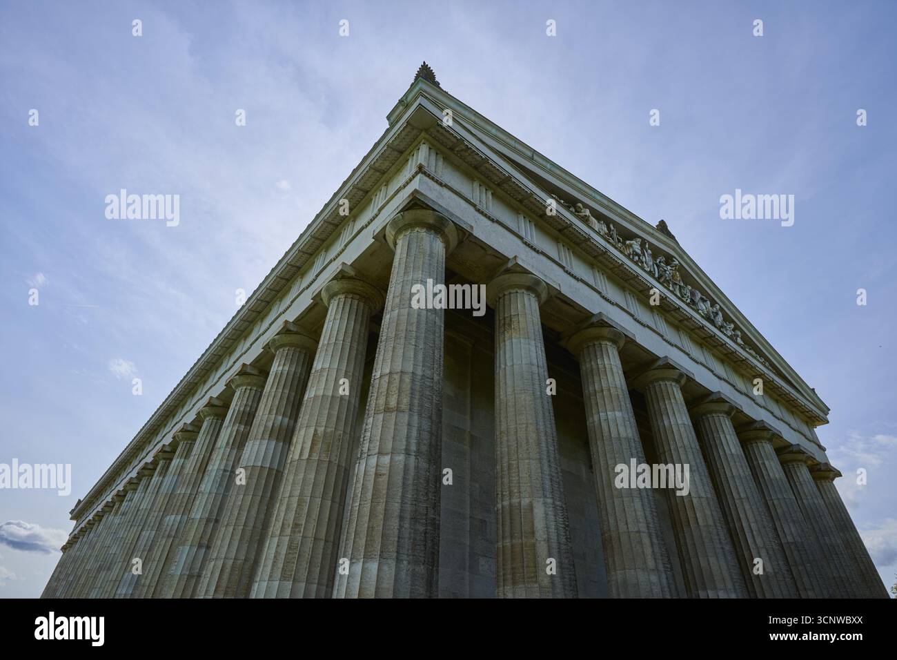 Impressive towering columned building in front of a blue sky in low ...