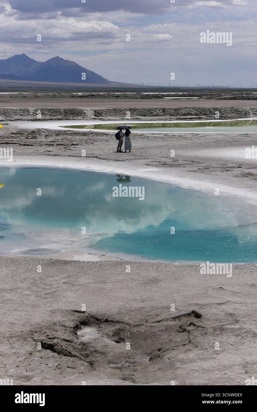 A young couple and their reflection in the turquoise waters at Jade ...