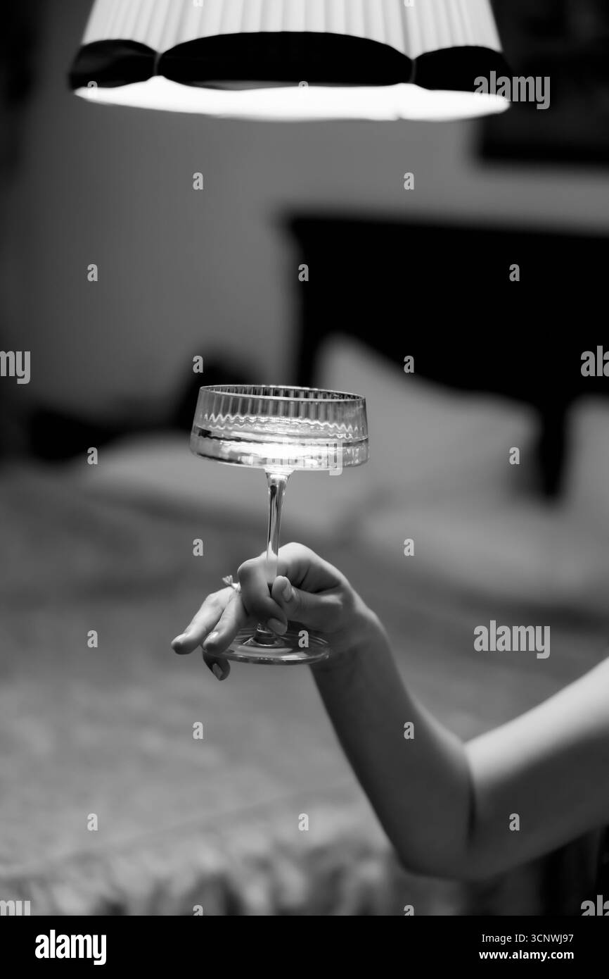 A monochrome image capturing an elegant hand gracefully holding a ...