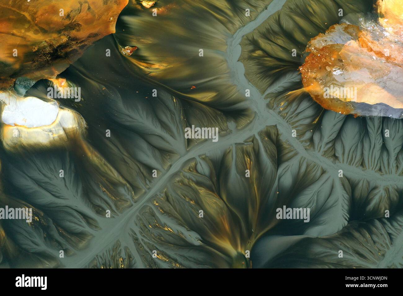 Flying over surreal patterns of flowing colorful mining chemical ...