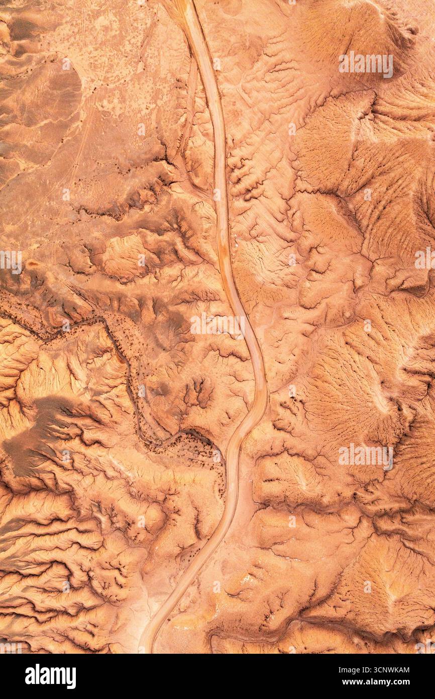Captivating aerial view of a winding road cutting through the rugged ...