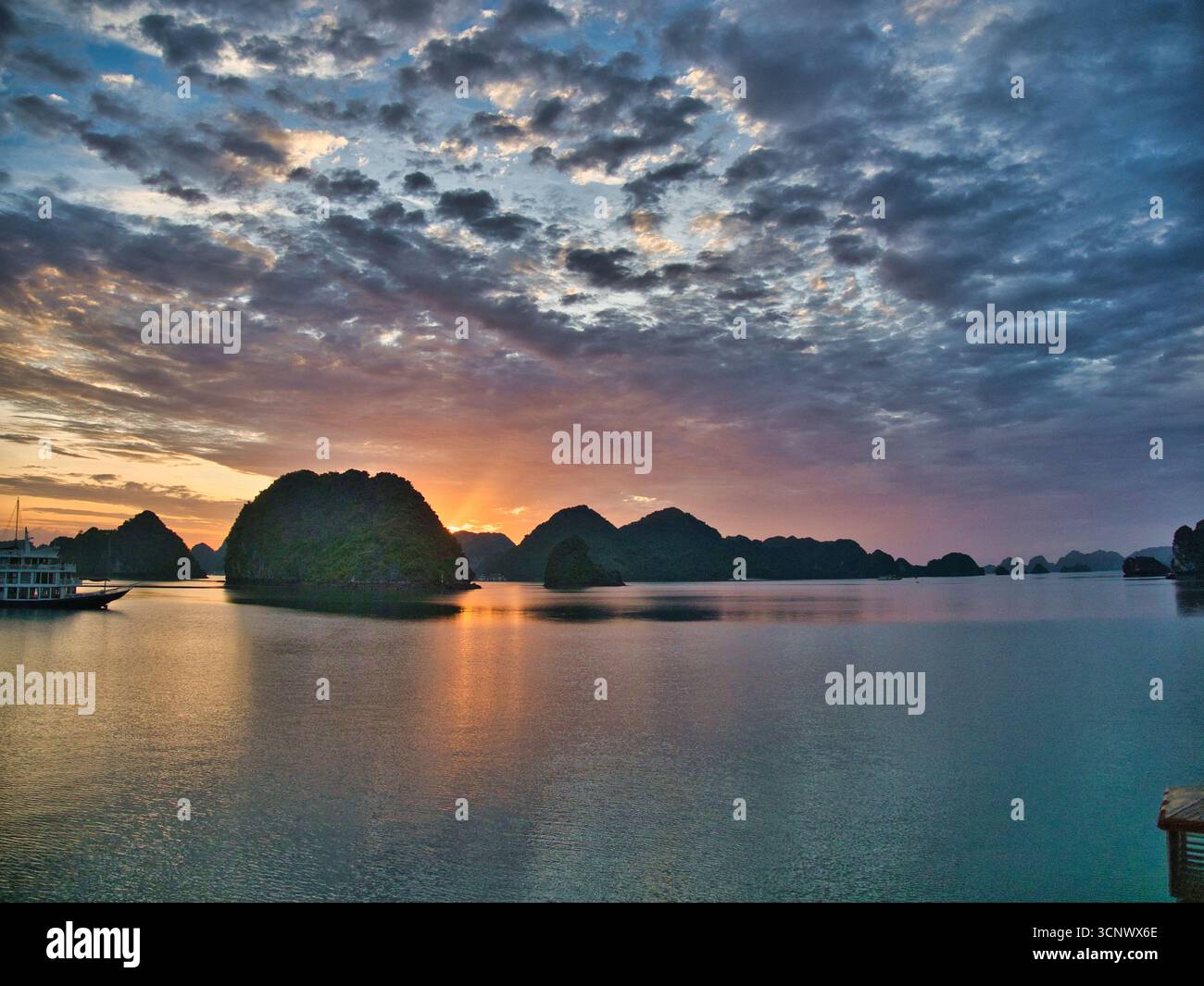 Vietnam's Halong Bay at sunrise - The calm, reflective waters of Halong ...