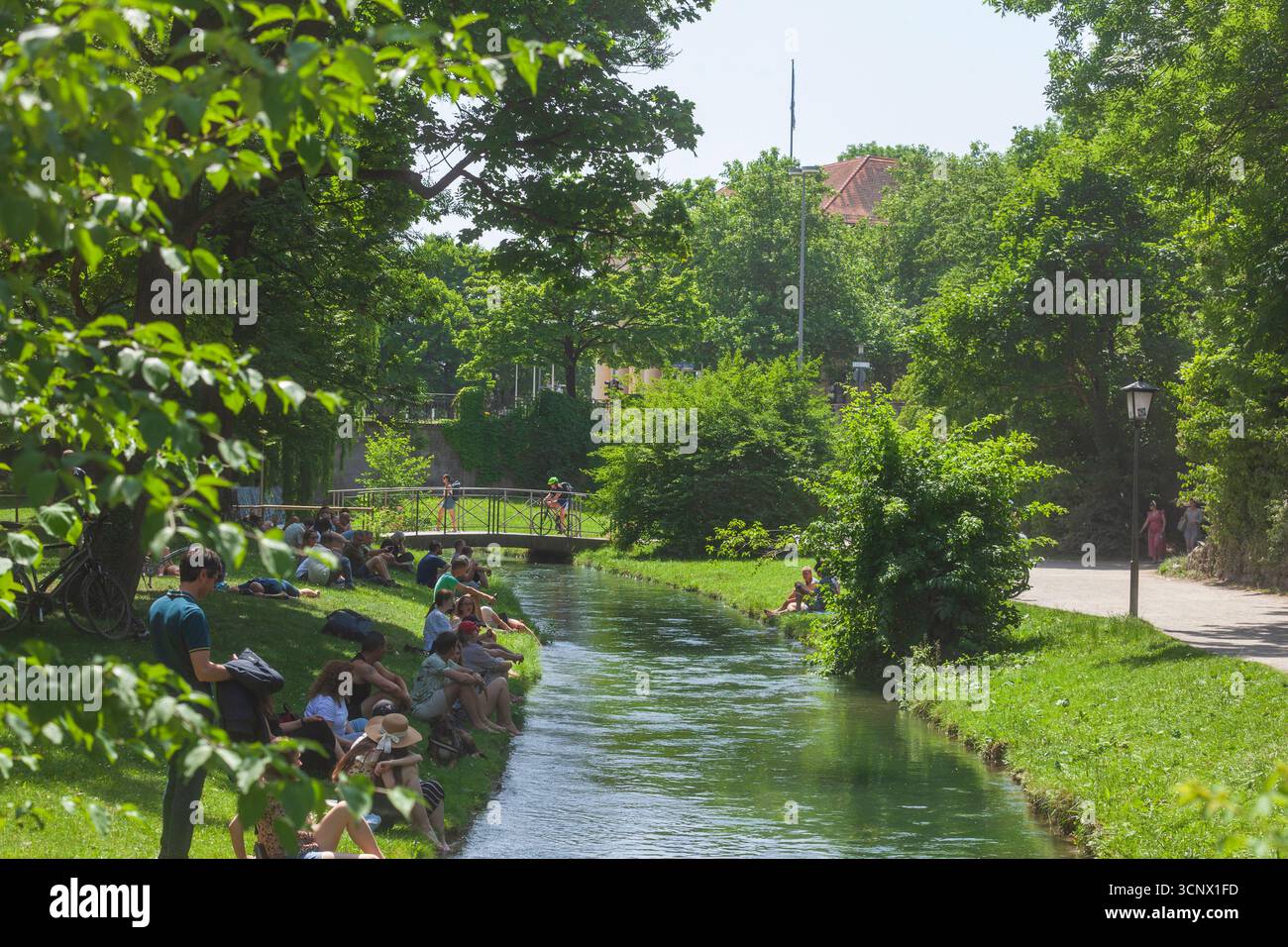 English garden with lawn, stream, and many people, Munich, Upper ...