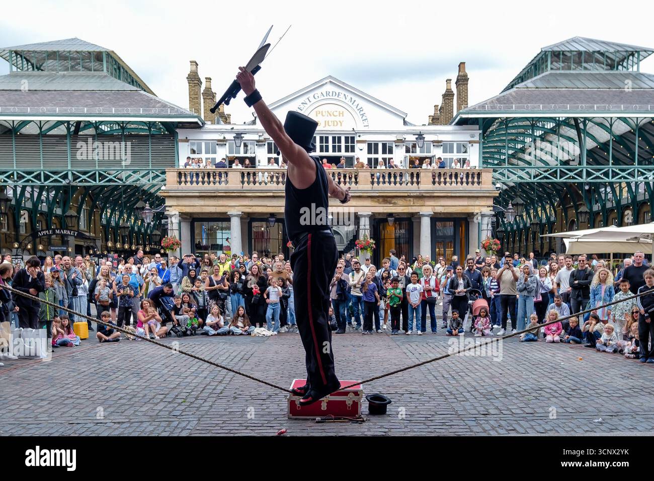 London, UK - May 25, 2025 : View of a street performer balancing on a ...