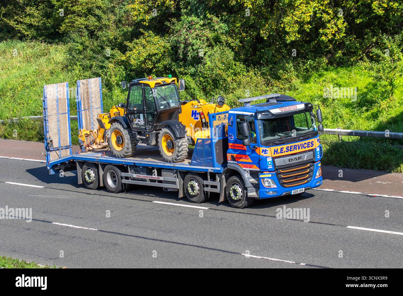 H.E.Services, DAF flatbed lorry transporting 2017 yellow JCB 540V140 ...