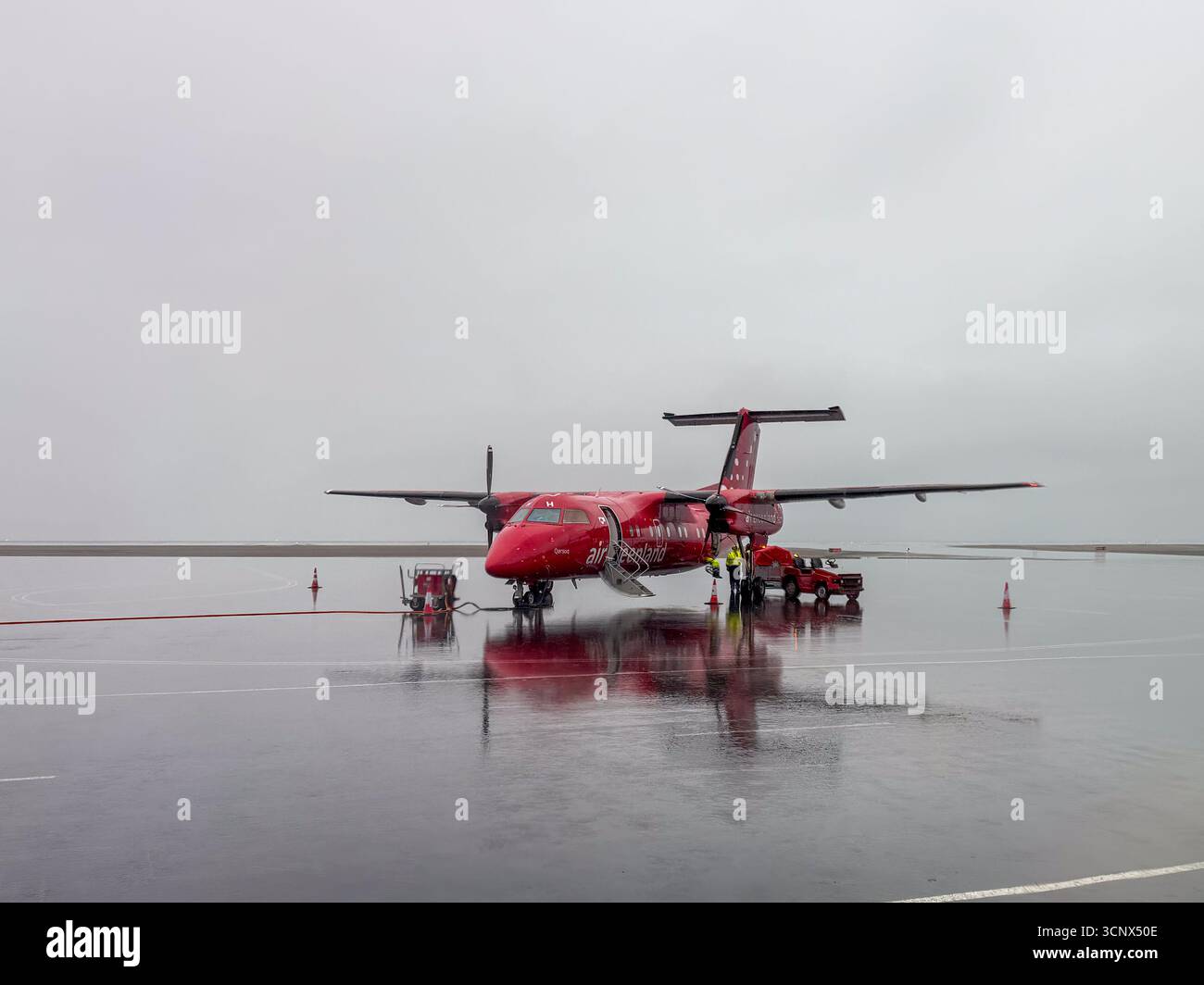 The red propeller aircraft connecting cities and islands in Greenland ...