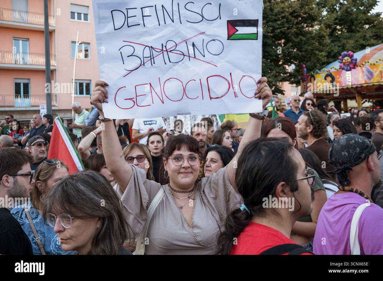 A protester holds a placard “define (not) child (barred), genocide ...