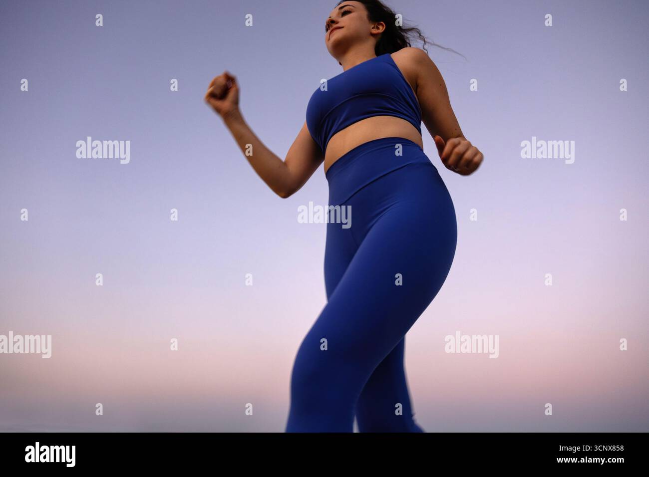 Woman running sunset captured hi-res stock photography and images - Alamy