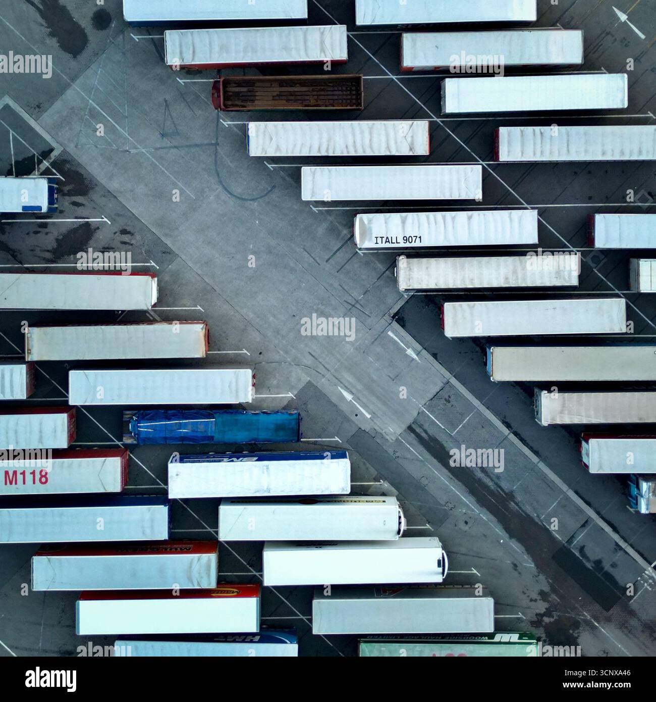 Aerial view of orderly rows of shipping containers creating a geometric ...