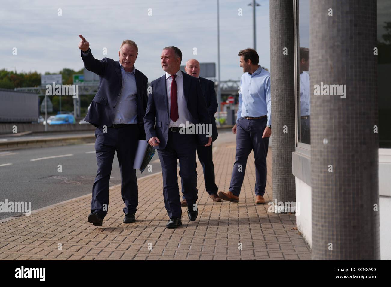 Housing Secretary Steve Reed (centre) walks with executive director ...