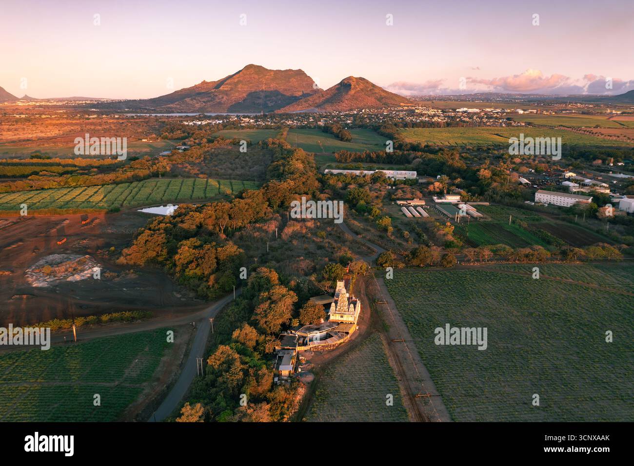 Aerial view of Maha Kalyug Mandir bathed in the soft glow of sunset ...