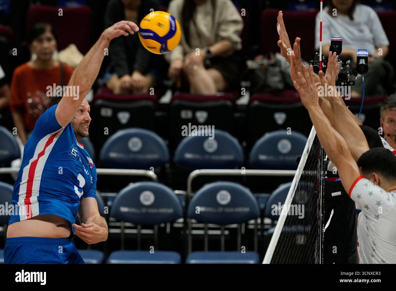 Jan Galabov, left, of the Czech Republic hits the ball against Tunisia ...