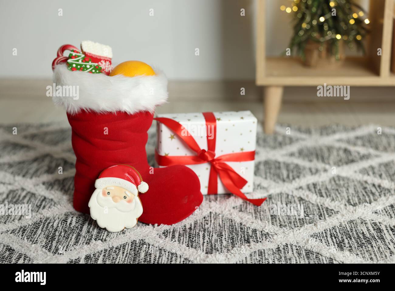 Saint Nicholas Day tradition. Red boot with treats and gift in room ...