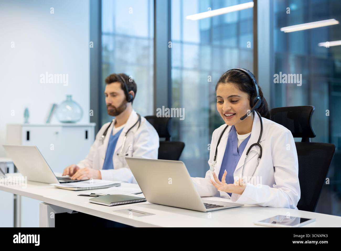 Medical professionals working in a modern office, providing remote ...