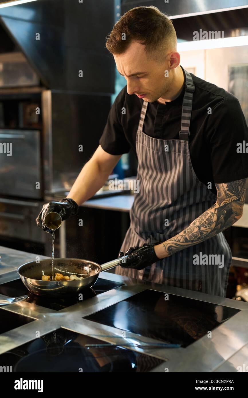 Young adult Caucasian man with tattooed arm and short hair wearing ...