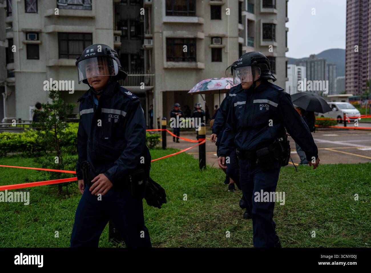 Hong Kong During Typhoon Ragasa Police officers wearing helmets at Heng ...