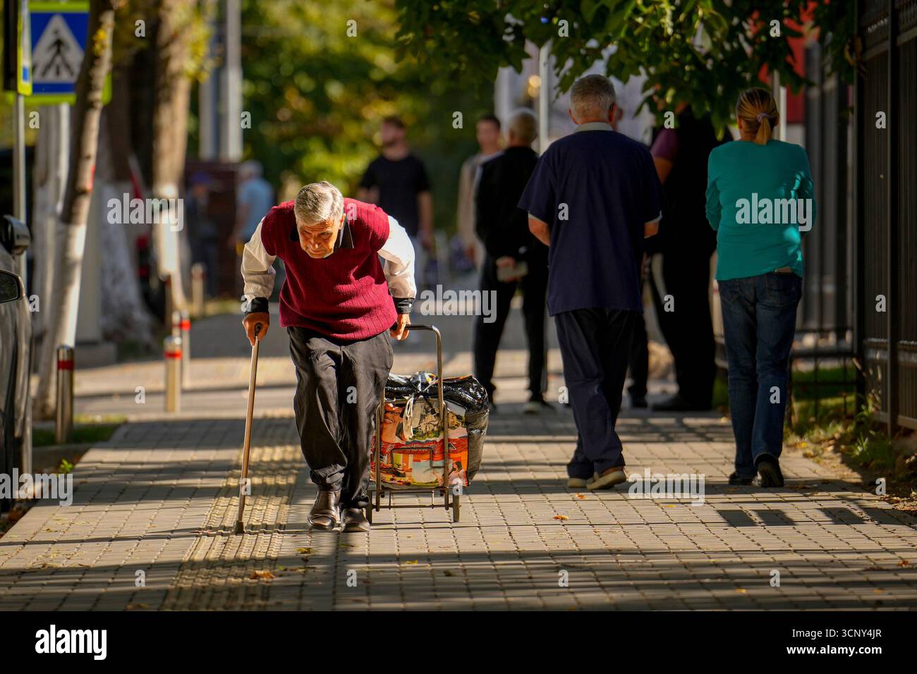An elderly man walks in Chisinau, Moldova, Tuesday, Sept. 23, 2025 ...