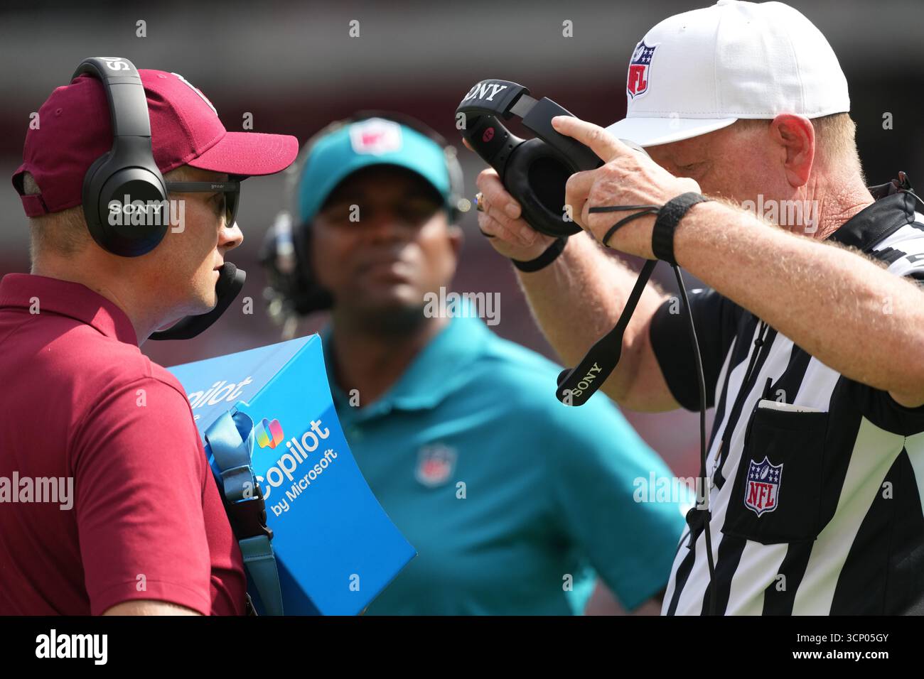 NFL Referee Carl Cheffers uses a headphones while reviewing a play ...